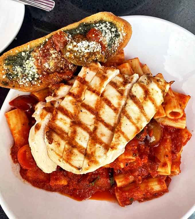 Rigatoni with grilled chicken creates the ultimate comfort food experience &ndash; each tube capturing the perfect amount of robust tomato sauce and melted cheese.