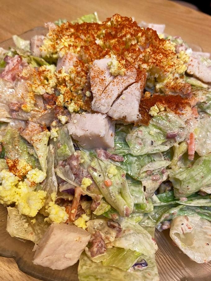 Salads piled high with fresh greens, protein, and toppings that make healthy eating feel like a celebration, not a chore.