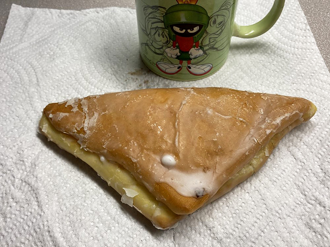 A classic apple fritter triangle &ndash; where caramelized cinnamon-apple chunks meet tender dough in perfect harmony.