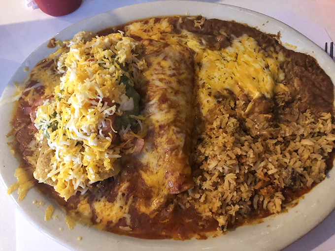 Crunch meets ooze in this Tex-Mex tango. The flautas stand at attention, ready to be devoured, while the enchilada lounges in a pool of savory sauce.