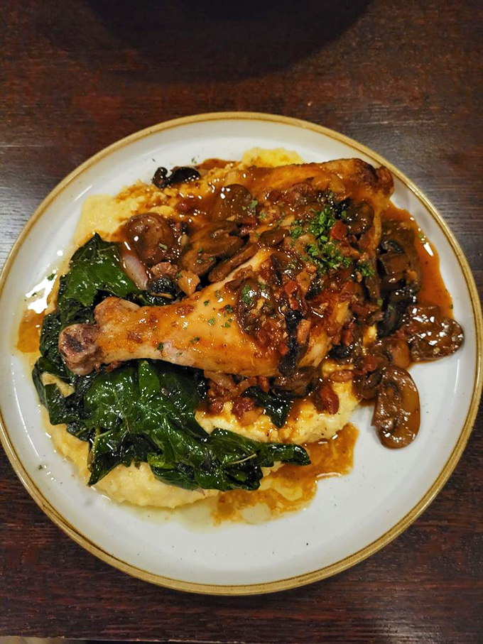 Chicken Marsala: Tender chicken nestled on creamy polenta with mushrooms and a wine sauce that makes you want to lick the plate. No judgment here!