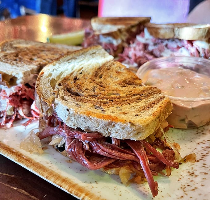 The classic Reuben in all its glory, with melted Swiss creating those cheese pulls that make you believe in sandwich magic.