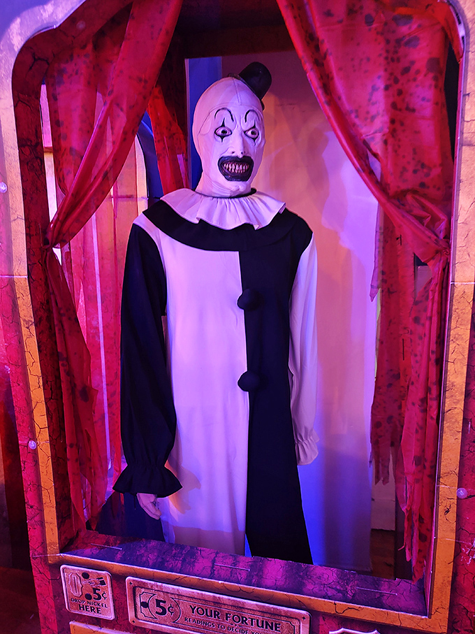 This creepy clown mannequin seems to watch visitors through the blood-red curtains, waiting for the perfect moment to make an appearance.