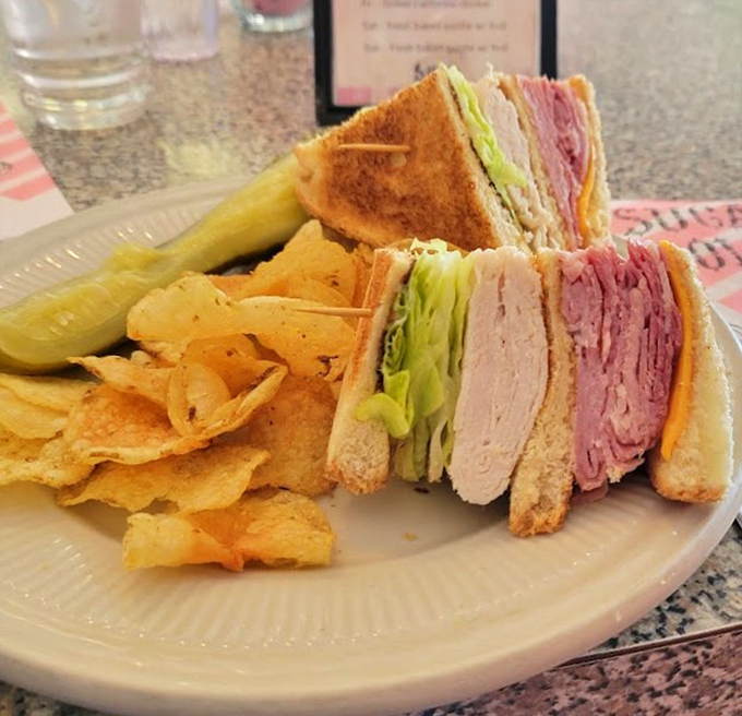 The club sandwich stands tall and proud, a tower of deli meats and fixings that says, "Yes, we know why you're really here."