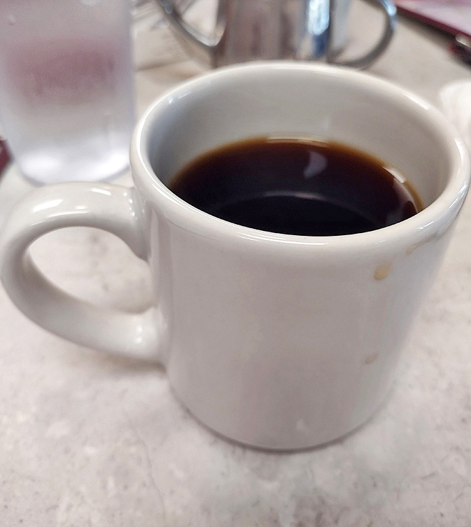 That classic diner mug with green stripes isn't just serving coffee – it's delivering liquid motivation in a vessel that feels like coming home.