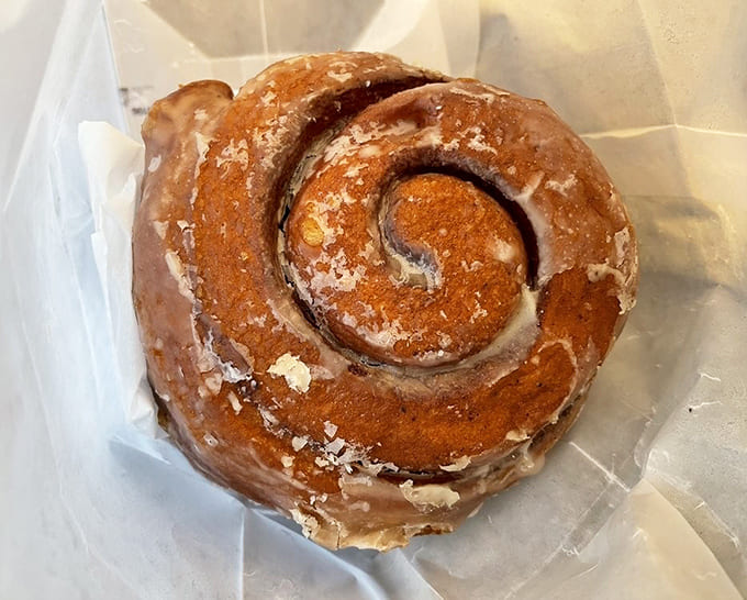 That honey bun spiral is hypnotic, drawing you in with its cinnamon-sugar swirls and sweet, sticky glaze coating.