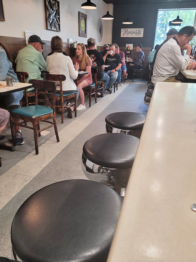 Where regulars perch on swivel stools, trading local gossip while coffee mugs are refilled without asking.