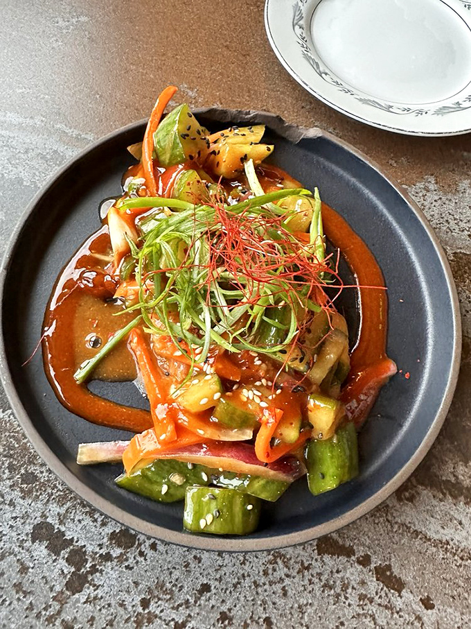 Bright vegetables and aromatic herbs float atop this spicy creation &ndash; a feast for the eyes before it becomes a party for your palate.