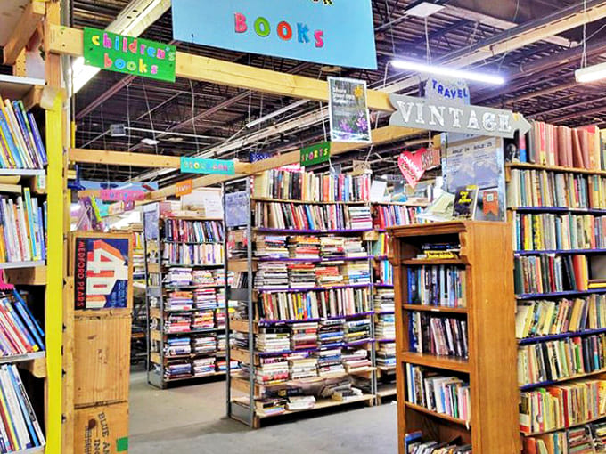 Books as far as the eye can see, organized yet wonderfully overwhelming. That yellow line on the floor? More of a suggestion than a rule.