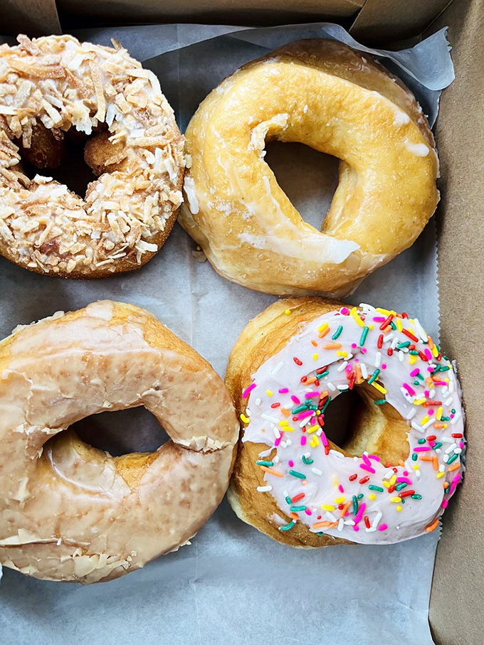 Donut heaven in a box! From classic glazed to sprinkle-topped creations, each one represents a different path to breakfast bliss.