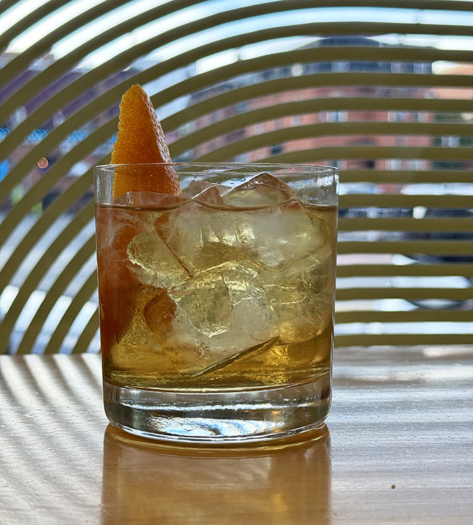 This isn't just a cocktail, it's liquid amber catching the light, with an orange peel twist that's practically winking at you from the glass.