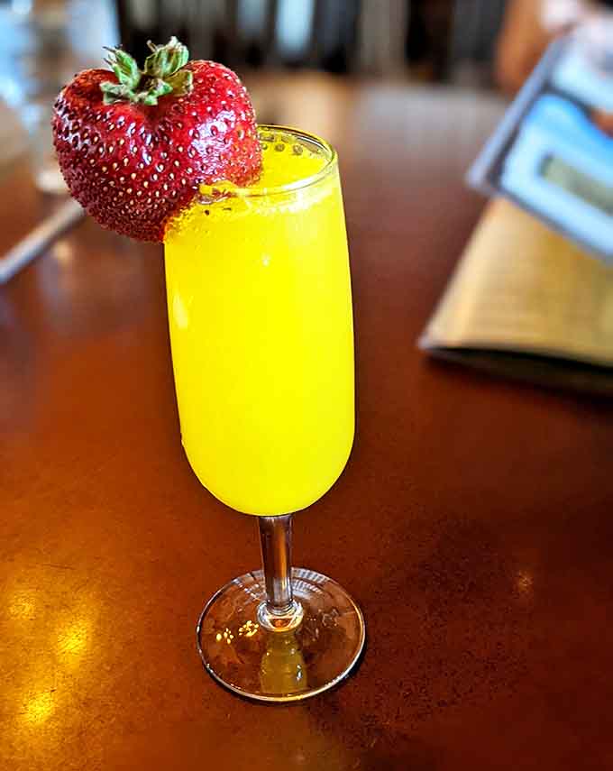 Drink: Liquid sunshine in a flute, crowned with a strawberry sentinel – just enough champagne to make your mother-in-law's stories interesting.
