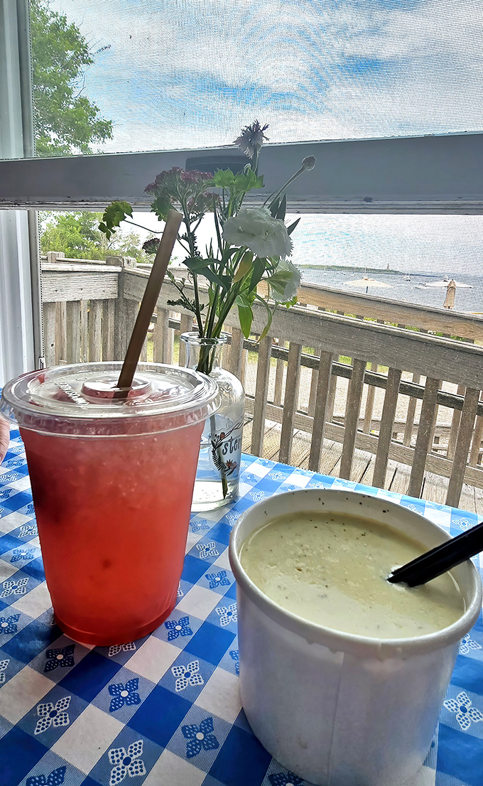 A refreshing fruit drink and creamy chowder create the perfect pairing, with ocean views framed by summer wildflowers.