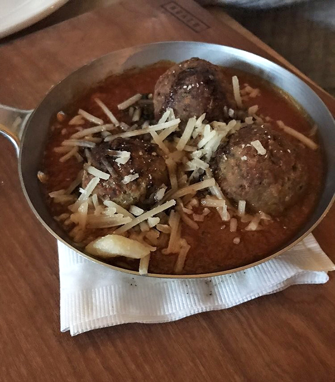 These aren't just meatballs&mdash;they're flavor bombs swimming in a tomato sea, topped with a snowfall of freshly grated cheese.