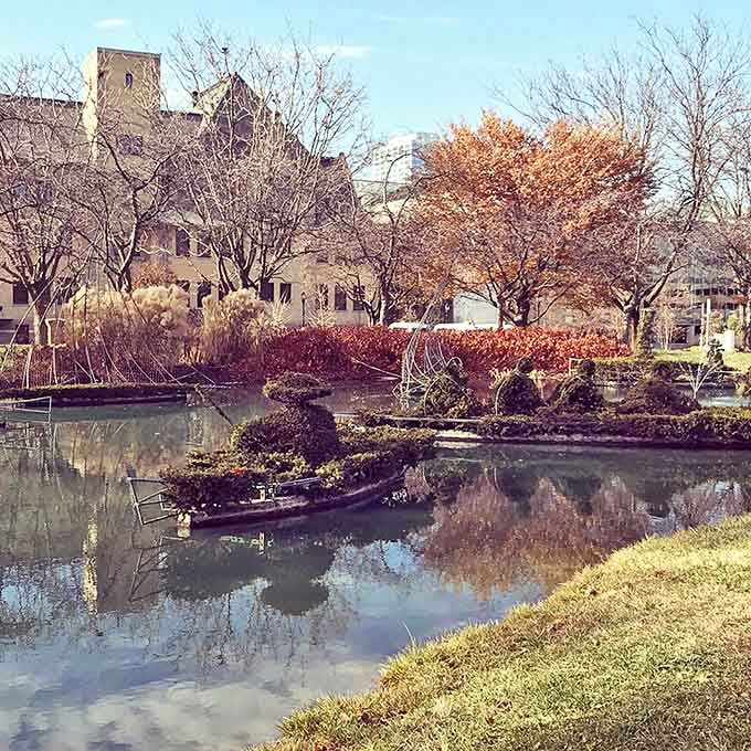 Floating topiary figures create the illusion of a Sunday boating excursion, their reflections completing the artistic illusion.