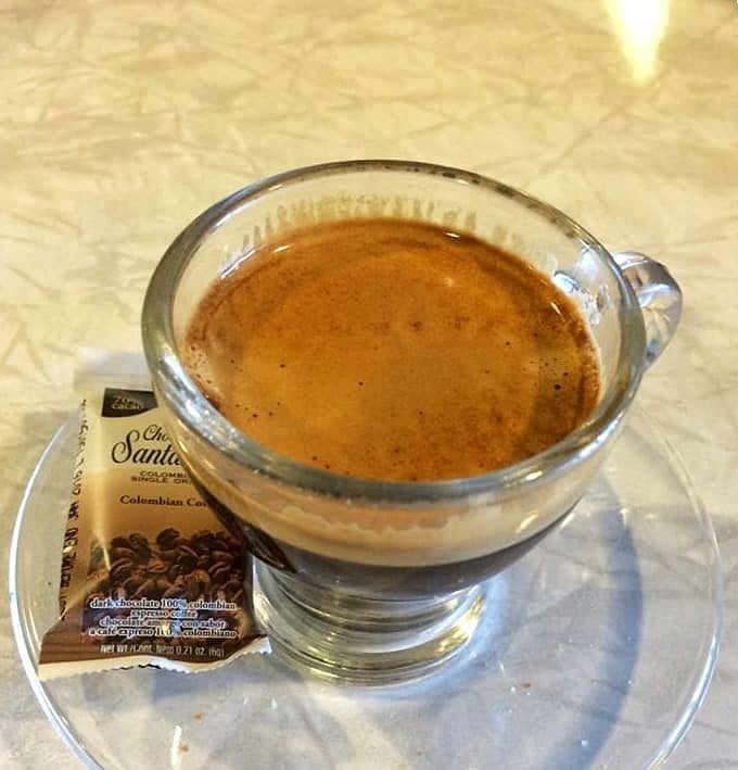 A double espresso served in proper glassware, because even your morning caffeine fix deserves to be treated with respect.