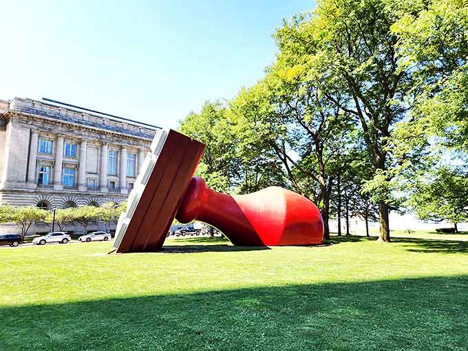 Bathed in sunlight, the Free Stamp's bold colors pop against the blue sky, creating a perfect photo opportunity for Cleveland visitors.