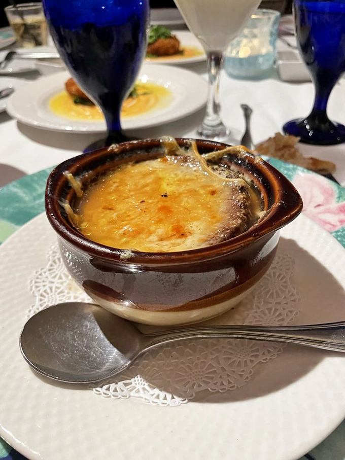 The Bermuda Triangle Onion soup transforms a French classic with caramelized onions, shallots, and a fontina cheese toast crown.