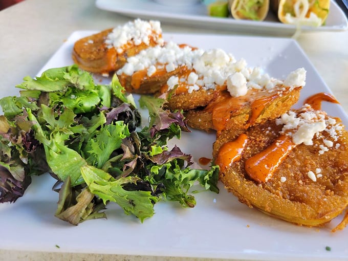 Fried green tomatoes topped with remoulade and crumbled cheese &ndash; crispy, tangy, creamy perfection that'll have you speaking with a sudden Southern accent.
