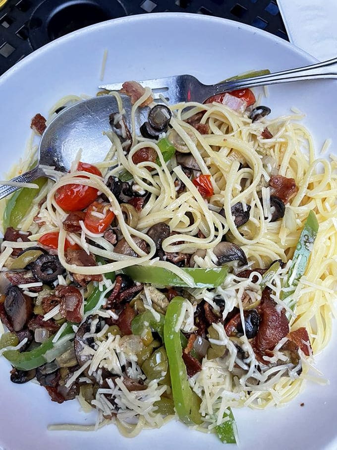 Arnold's Greek Deluxe pasta twirls with Mediterranean inspiration &ndash; olives, tomatoes, and peppers creating a colorful symphony around perfectly cooked spaghetti.