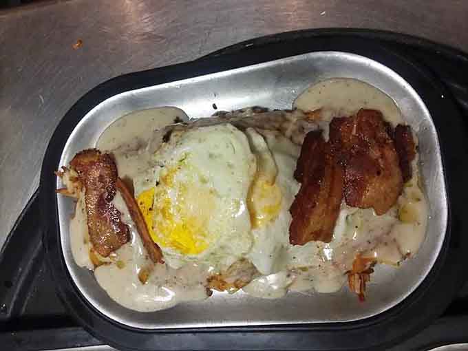 Biscuits swimming in creamy gravy with bacon and eggs, because sometimes breakfast needs to be a full-contact sport for your taste buds.