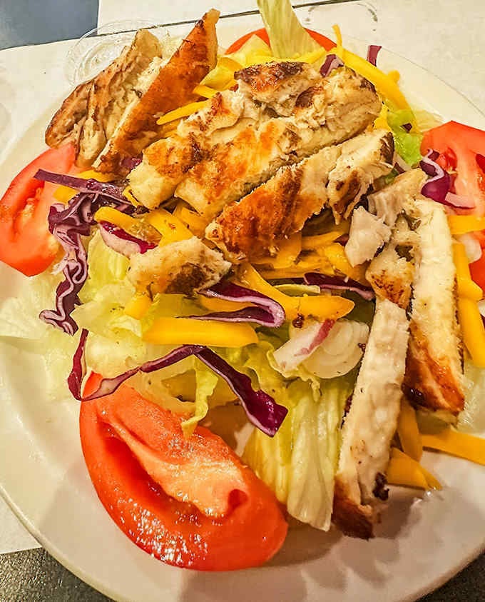 The grilled chicken salad proves that even the lighter options get serious attention, with perfectly seasoned chicken over fresh, crisp greens.