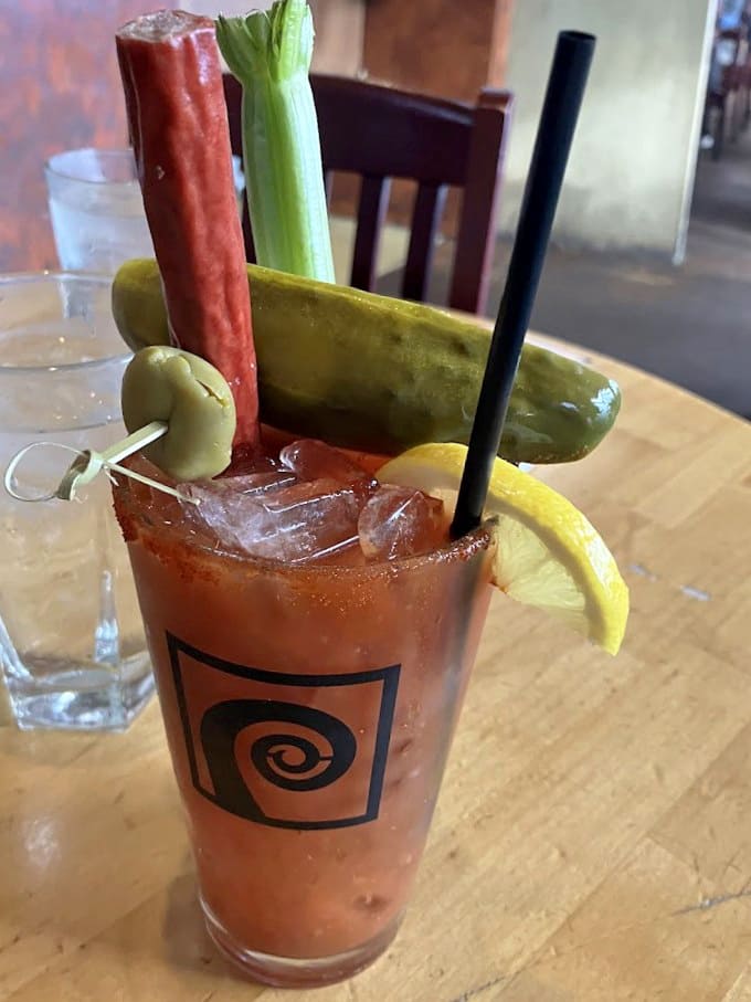 That Bloody Mary garnished with pickles and peppers looks like it's ready to cure whatever ails you, or at least make brunch legendary.