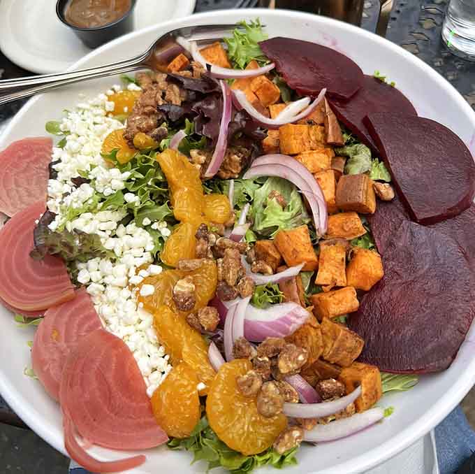 The Harvest Salad arranges roasted beets and sweet potatoes like edible art, making vegetables look almost too pretty to eat.