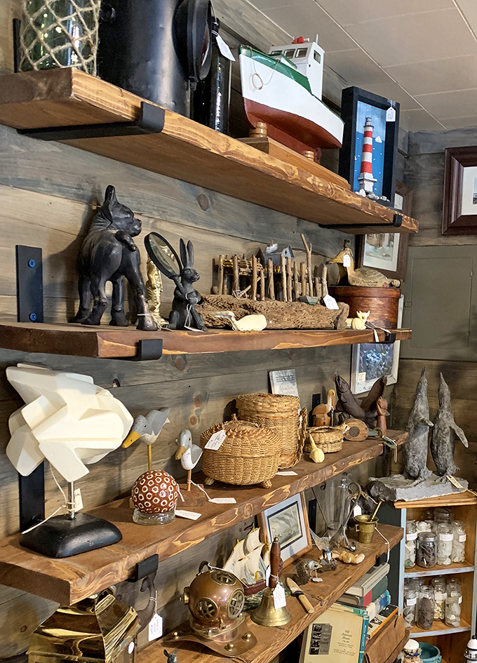 Nautical-themed shelving showcases carved wooden animals and maritime collectibles &ndash; perfect for bringing Maine's coastal charm into any home.