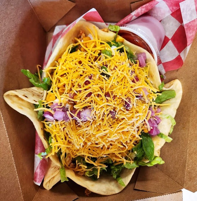 The taco salad arrives in an edible bowl, piled high with fresh toppings that make healthy eating feel indulgent.