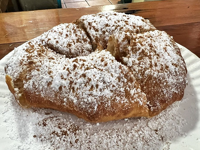Dessert perfection: powdered sugar and cinnamon dust this pillowy fry bread, creating a sweet finale that'll have you plotting your next visit.