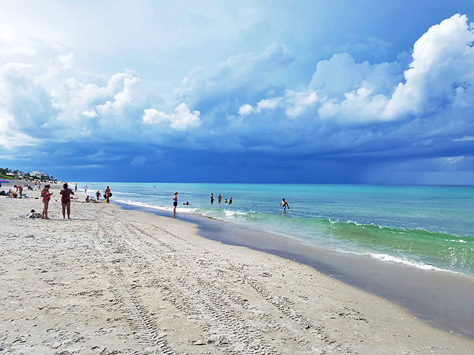 Storm clouds create dramatic backdrop as beachgoers squeeze in one last swim &ndash; Mother Nature's way of adding theatrical lighting to your vacation photos.