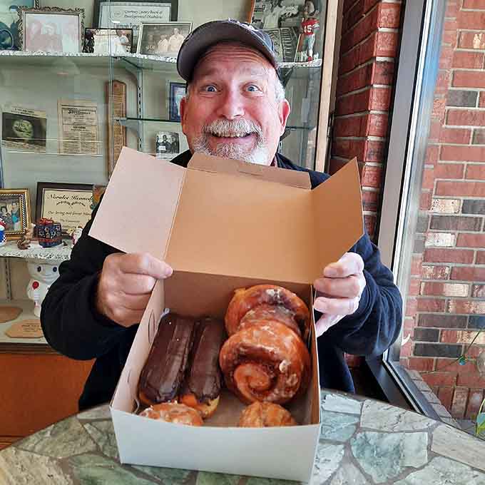 That smile says it all: this is what happens when you open a box of Kennedy's pastries and realize you've made excellent life choices.
