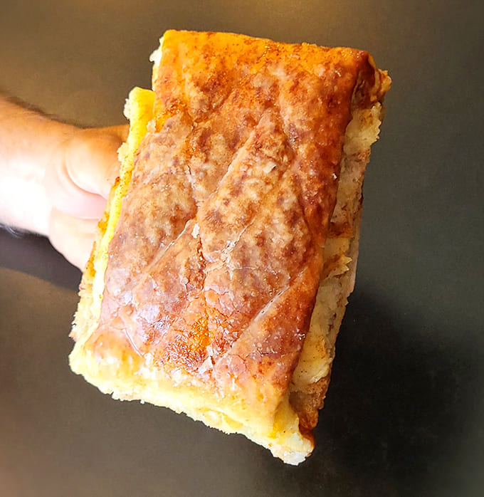 That apple fritter's unique shape and generous size suggest someone in the kitchen understands that bigger really is better when it comes to pastries.