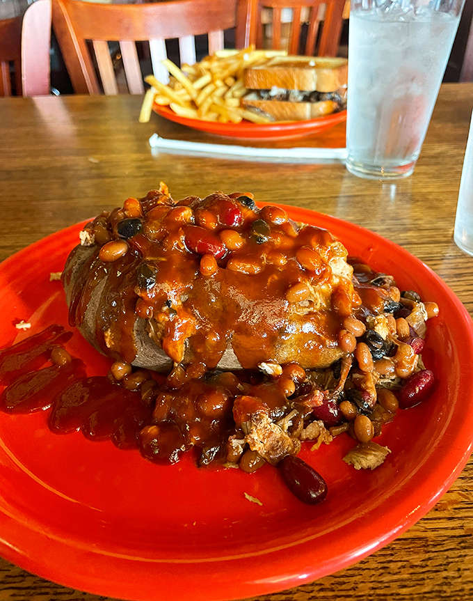 This loaded potato has more toppings than some people's entire meals, and that pulled pork situation is basically showing off at this point.