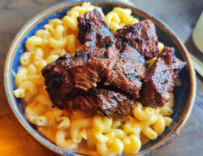 Tender smoked beef crowns a throne of creamy mac and cheese &ndash; comfort food royalty at its finest.