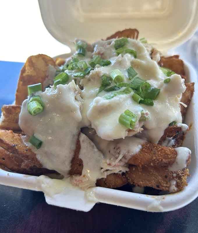 Crab-topped fries with creamy sauce bring coastal Maine flavors to comfort food in a combination that's pure genius.