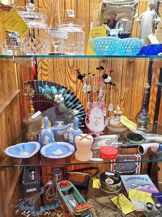 Delicate figurines, decorative fans, and vintage jewelry create a cabinet of curiosities that would make any collector's heart skip a beat.