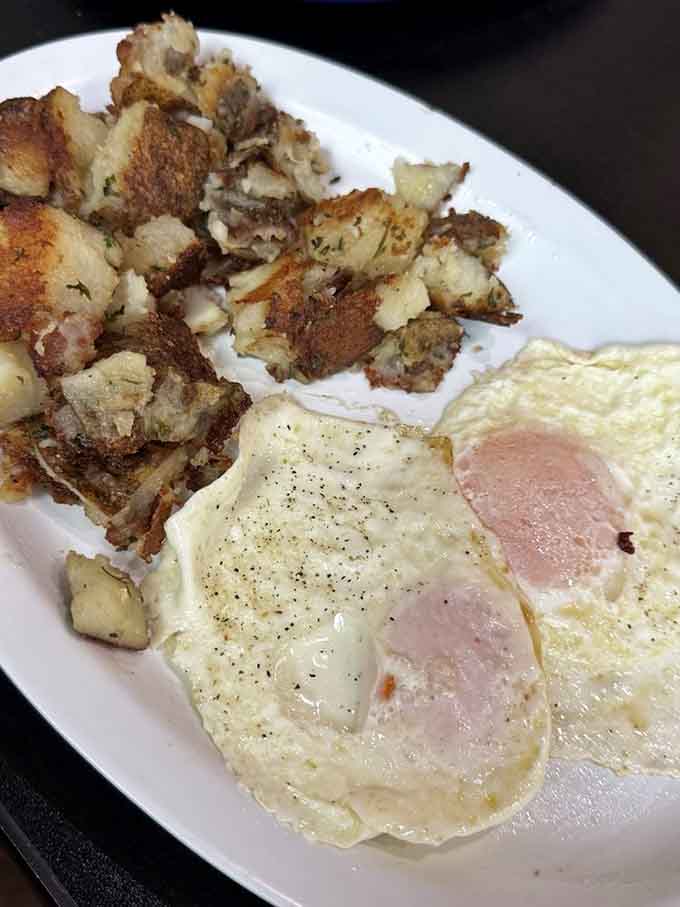 Home fries with that perfect golden crust alongside eggs cooked just right, the supporting cast that deserves its own standing ovation.