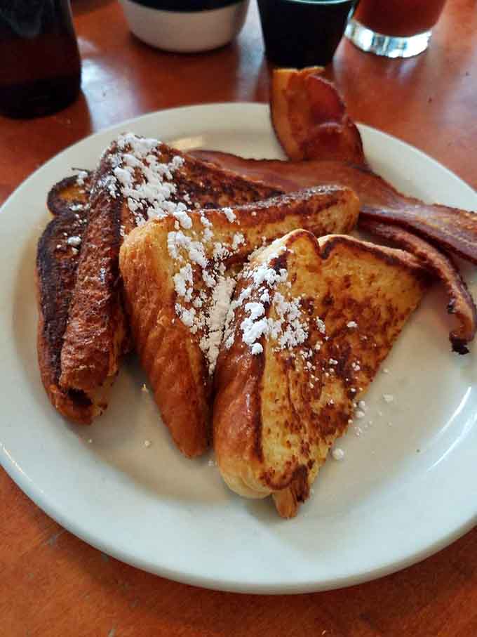 French toast done right means crispy edges, fluffy centers, and enough powdered sugar to make your inner child very happy.