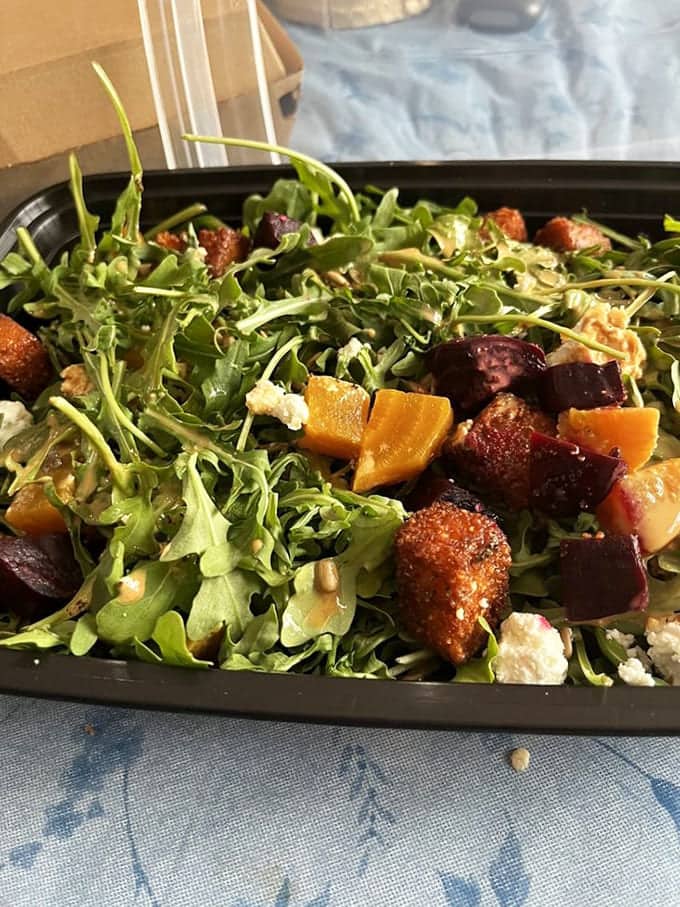 This beet salad brings together earthy sweetness and fresh greens, topped with crispy elements that add delightful textural contrast.