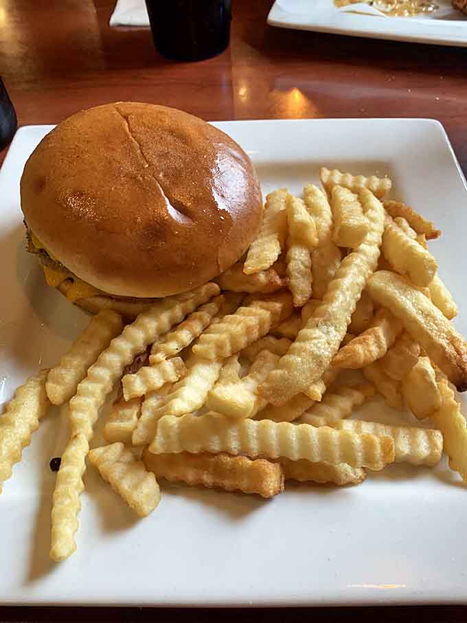 A double cheeseburger with crinkle fries represents classic American diner food executed exactly the way it should be, no apologies needed.