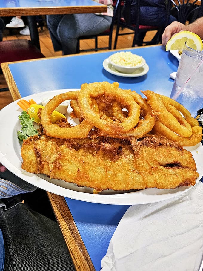 Golden-battered onion rings form a perfect crown around fish so fresh it might have been swimming this morning.