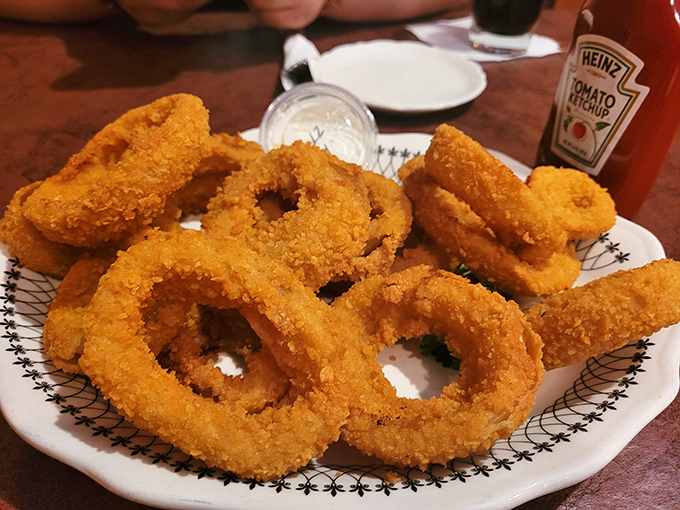 Onion rings stacked like golden halos &ndash; crispy, sweet, and large enough to double as bangle bracelets for giants.