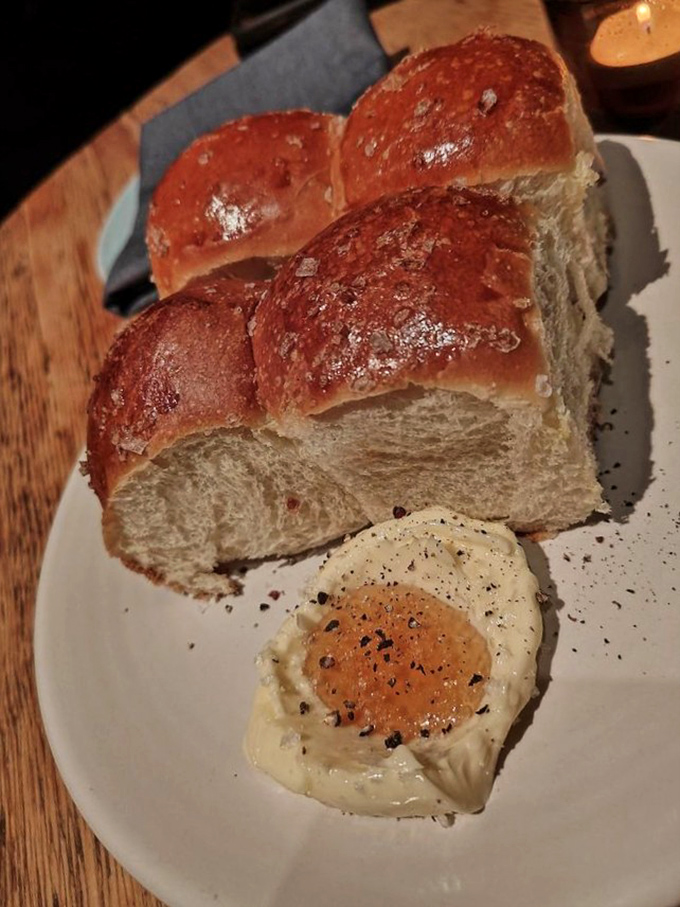 Parker House rolls with honey butter – the kind of bread that makes you question your life choices if you pass them up.