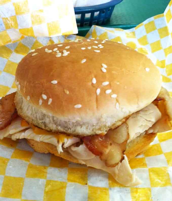 The smoked turkey sandwich stacked high enough to make your jaw work for its supper tonight.