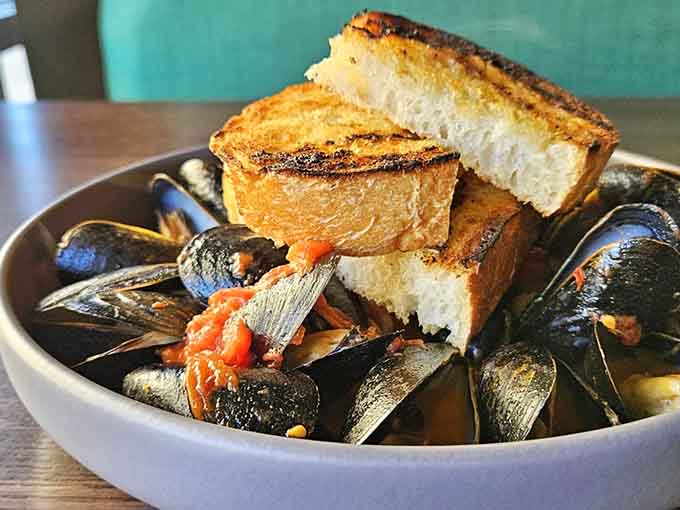 These mussels arrive in enough aromatic broth to make you seriously consider drinking it straight from the bowl.