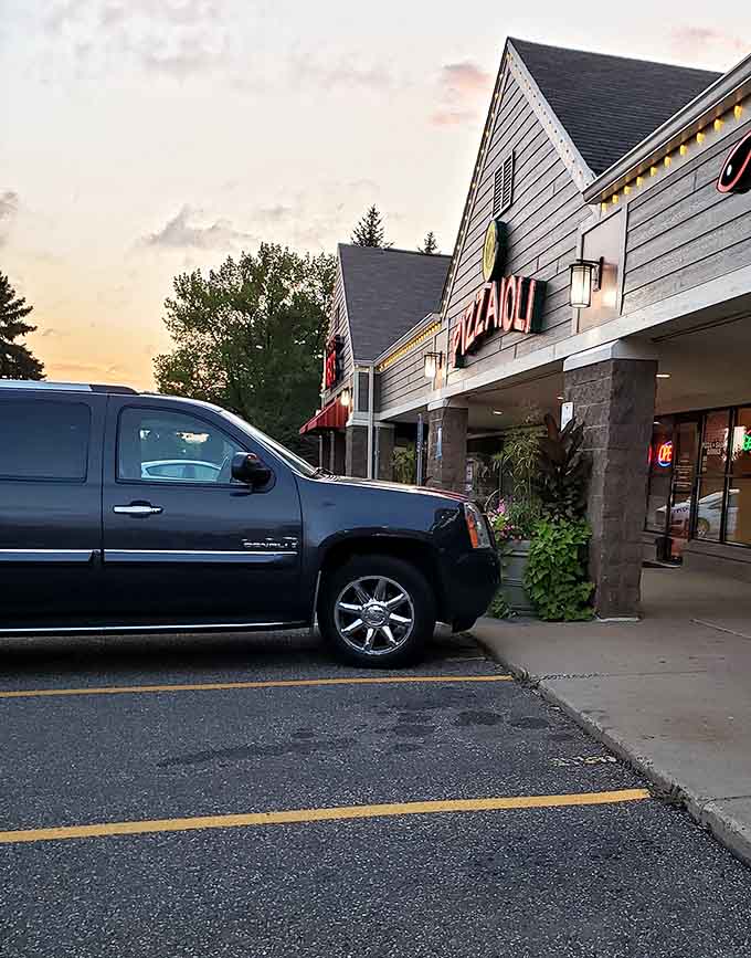 The parking lot at sunset looks almost poetic, though you're probably too focused on getting inside to appreciate the atmospheric lighting.