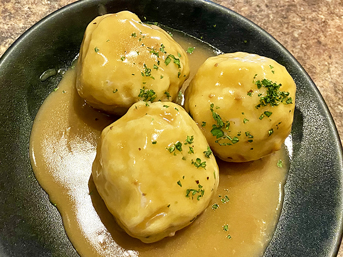 These potato dumplings swimming in savory gravy might just be what comfort food heaven looks like on a plate.
