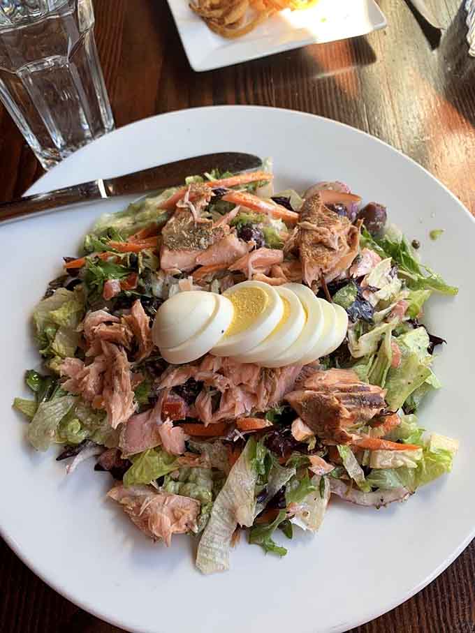 Fresh salmon tops a chopped salad that proves healthy eating doesn't mean sacrificing flavor or satisfaction at this North Woods cafe.